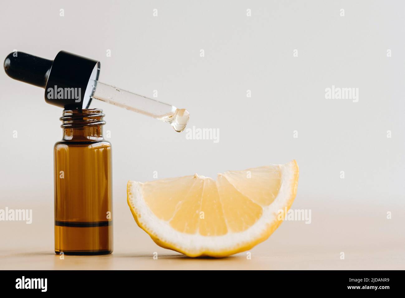 Essential oil in one bottle and lemon lying on the surface Stock Photo ...