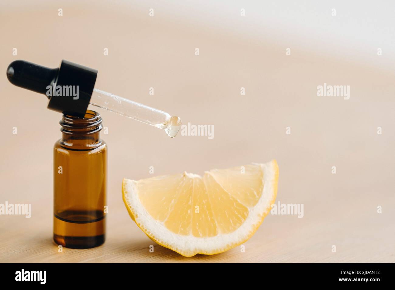 Essential oil in one bottle and lemon lying on the surface Stock Photo ...