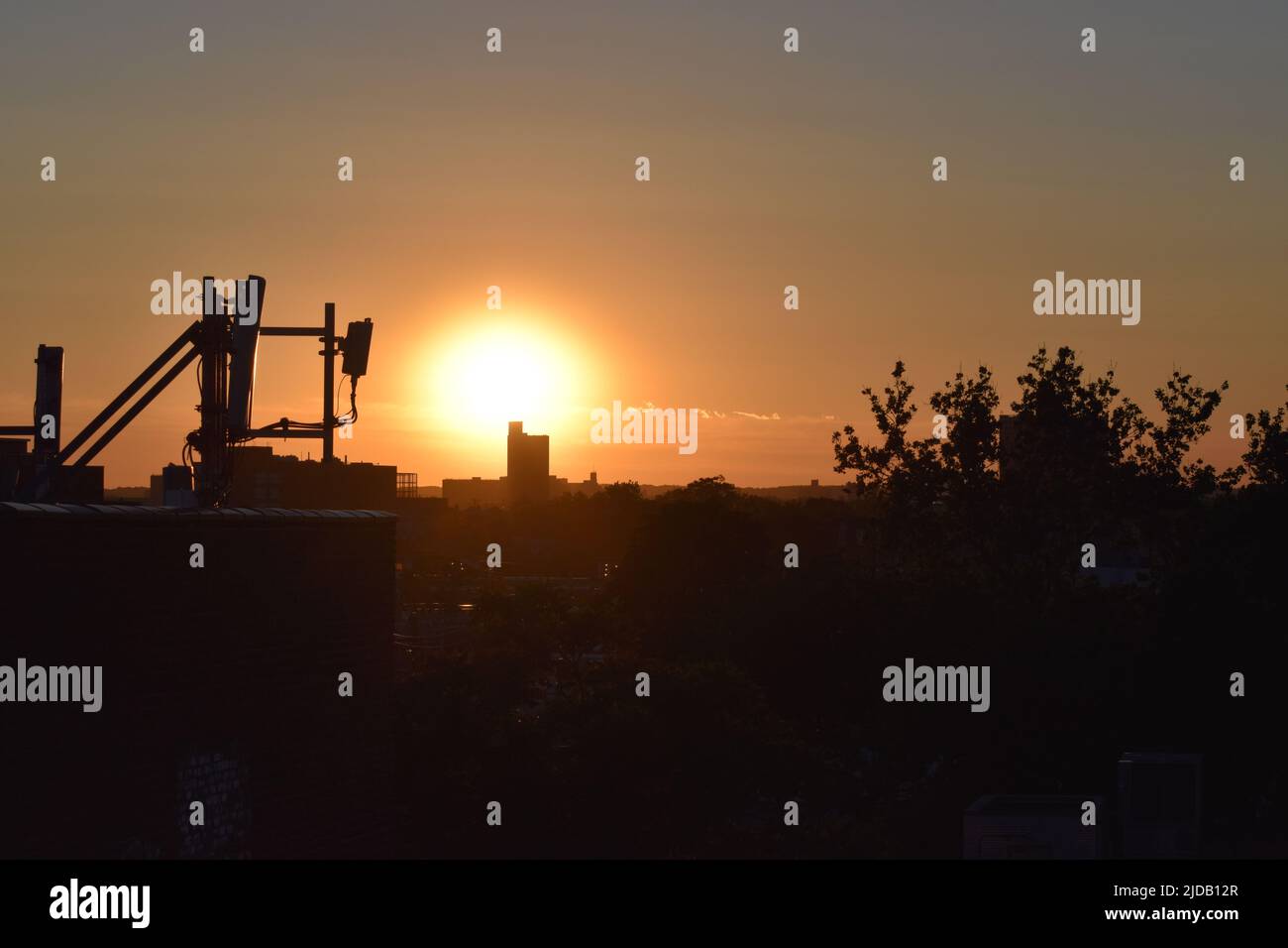 Sunset over a residential building is seen in The Bronx, New York City ...