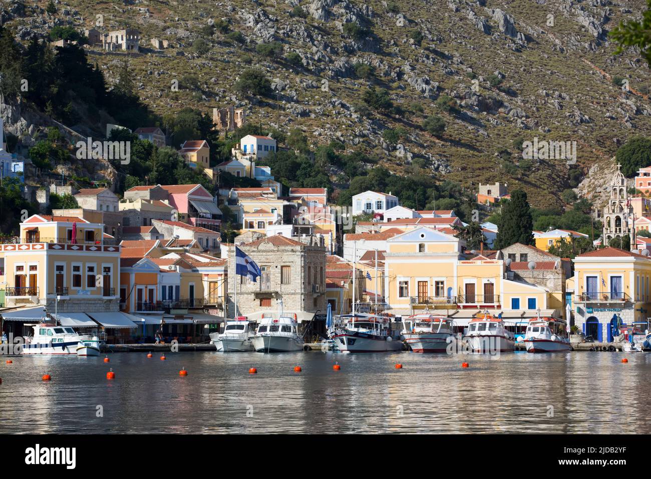 Boats moored along the shore at Gialos Harbor, Symi (Simi) Island ...