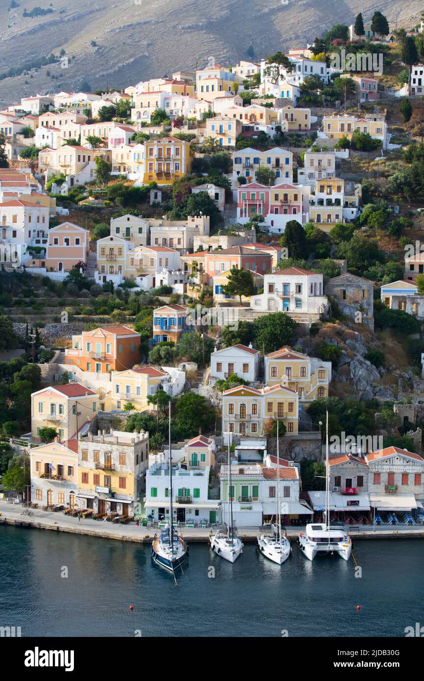 Overview of pastel colored buildings and sailboats moored along the ...