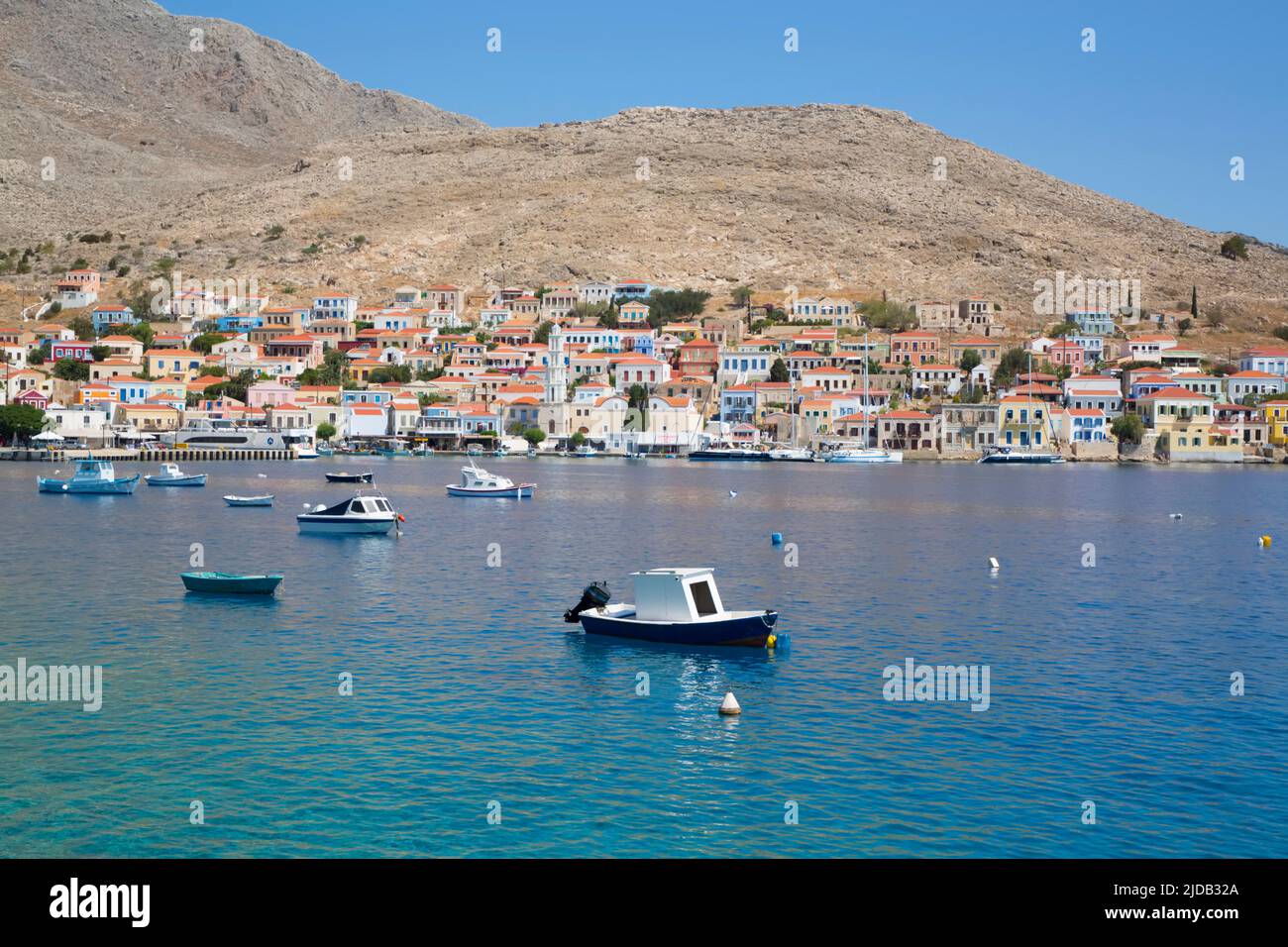 Fishing boats anchored off shore in the harbor at Emborio, the main ...