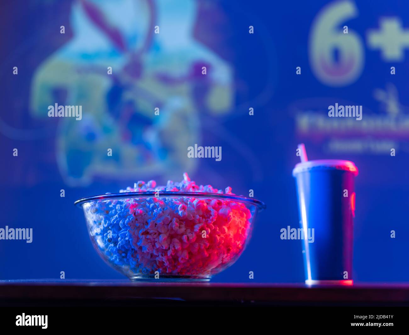 Relax in front of the big screen plasma TV screen. Popcorn in a glass ...