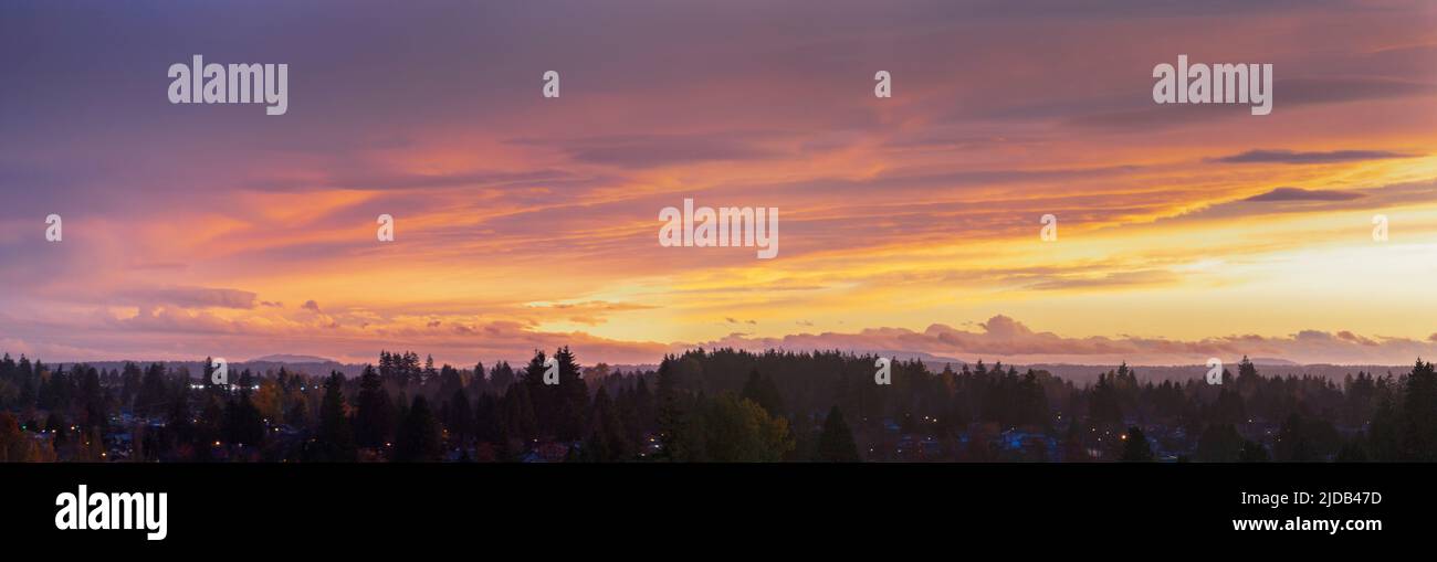 Panoramic of dramatic glowing sunset sky over land; British Columbia ...