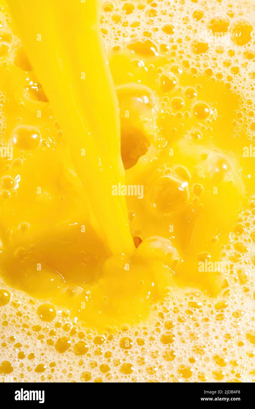 Closeup of splashing orange juice, top view. Splash of fresh sweet ...