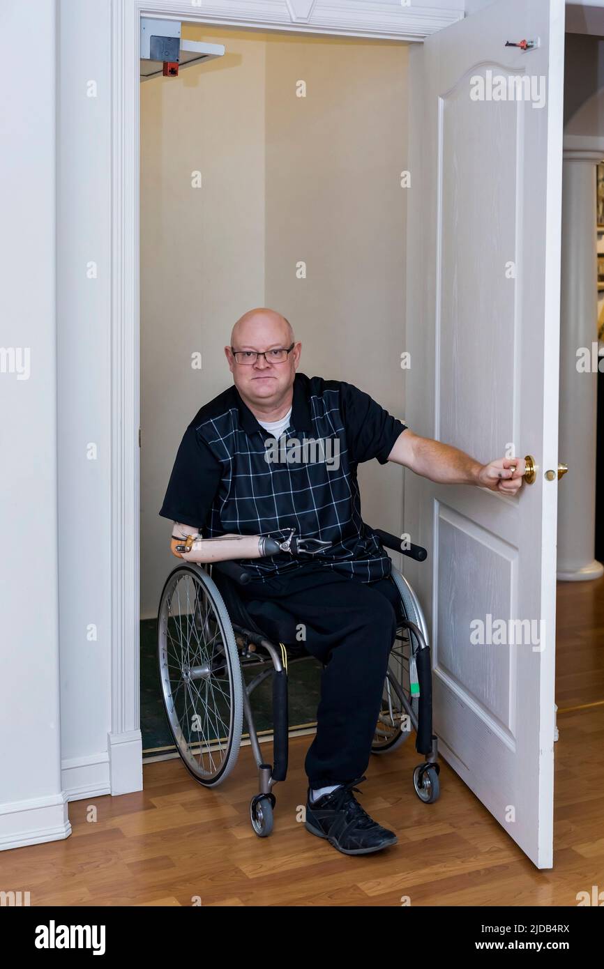 Man with double limb amputations entering home elevator; St. Albert ...