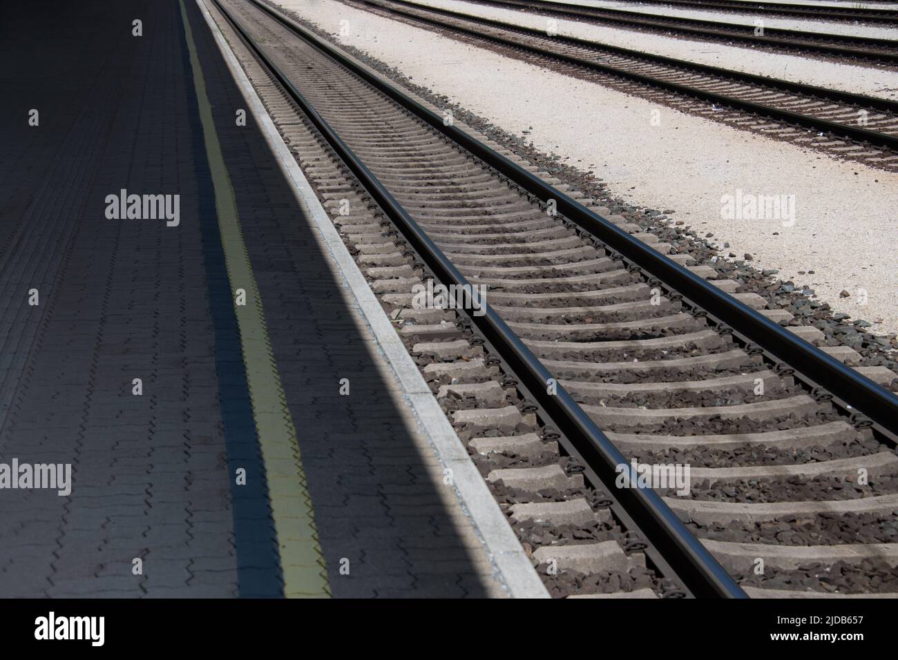 Close up partial view of platform paved with concrete blocks next to a ...