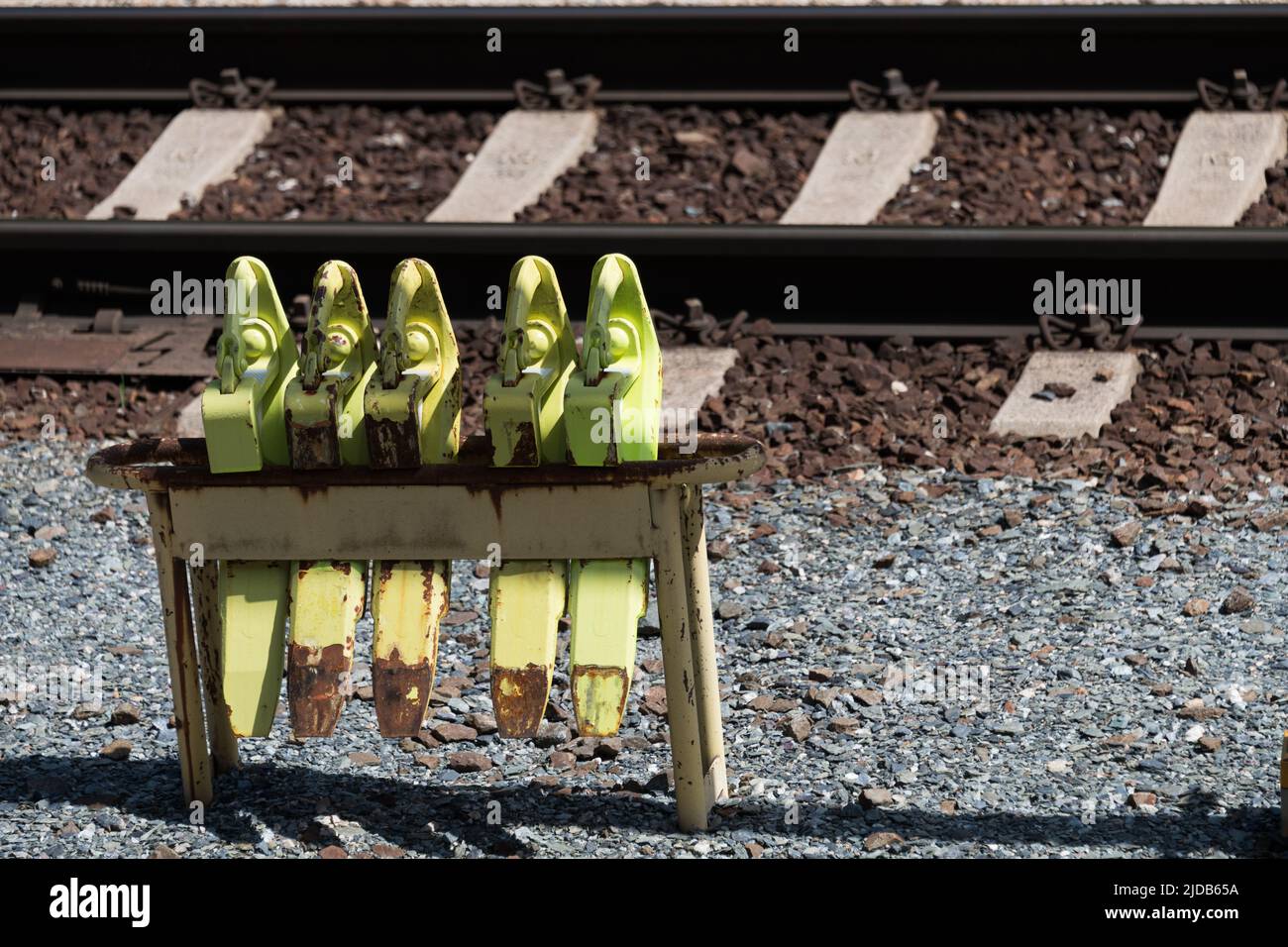 Close up of a metal stand with several steel brake shoes train stoppers ...