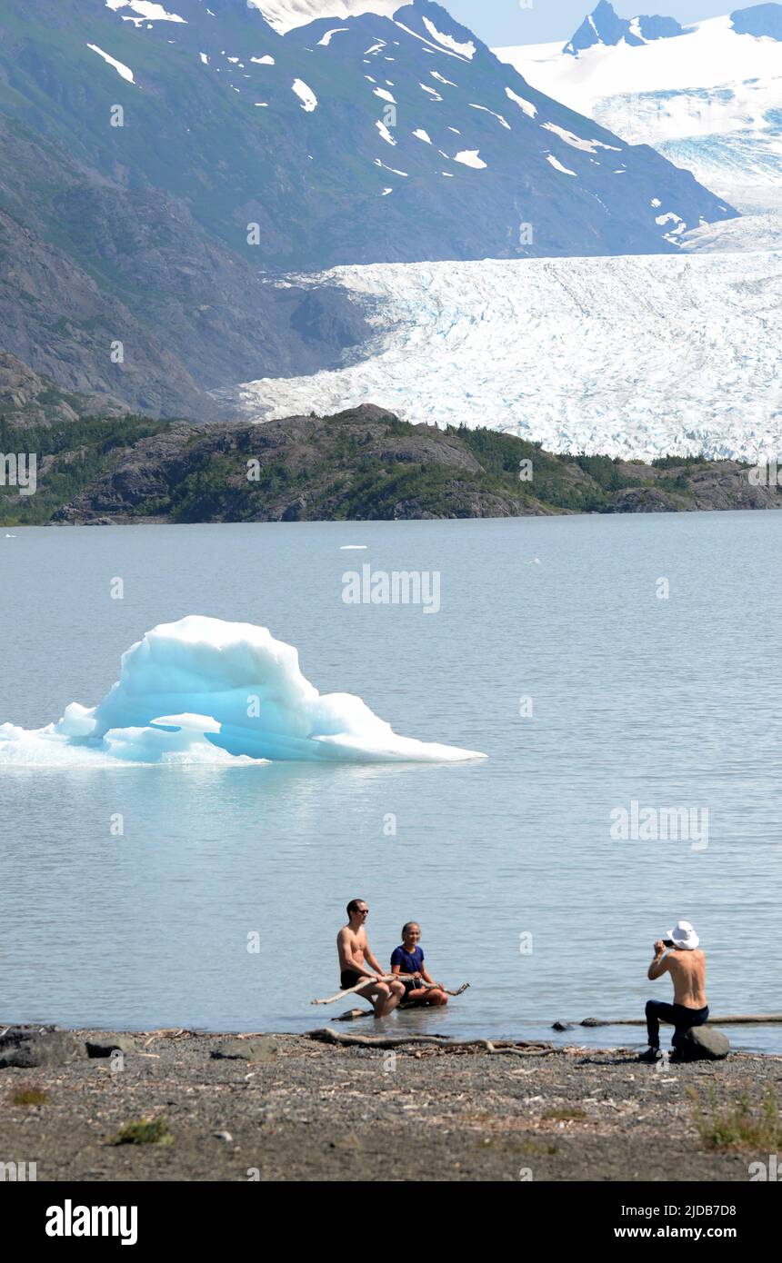 Hikers take a break for photos in the lake at Grewingk Glacier in ...