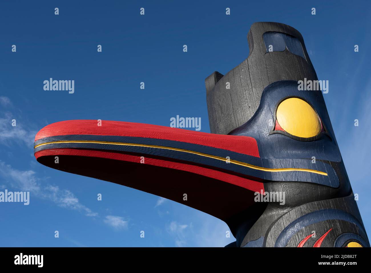 Totem pole, a type of Northwest coast art, against a blue sky; Tofino ...