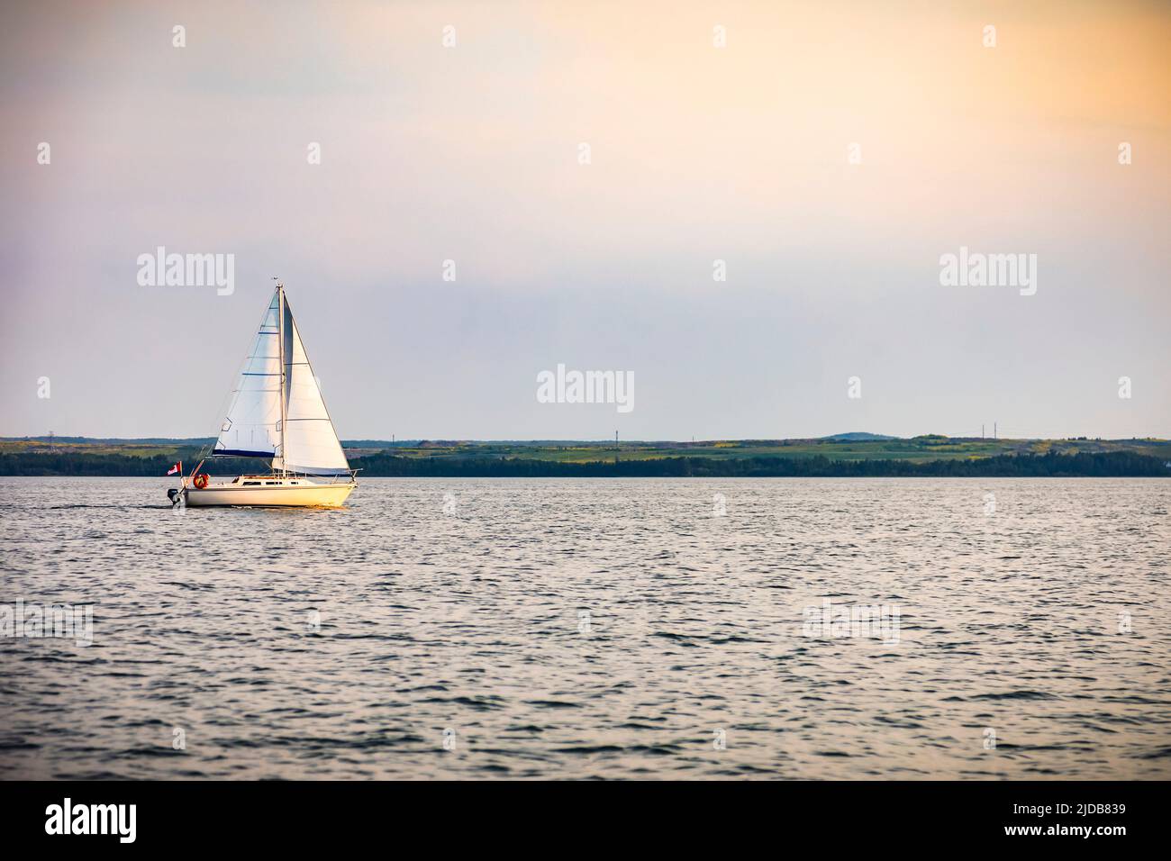 Sailboat on a sunset cruise on Lac Ste. Anne; Alberta Beach, Alberta ...
