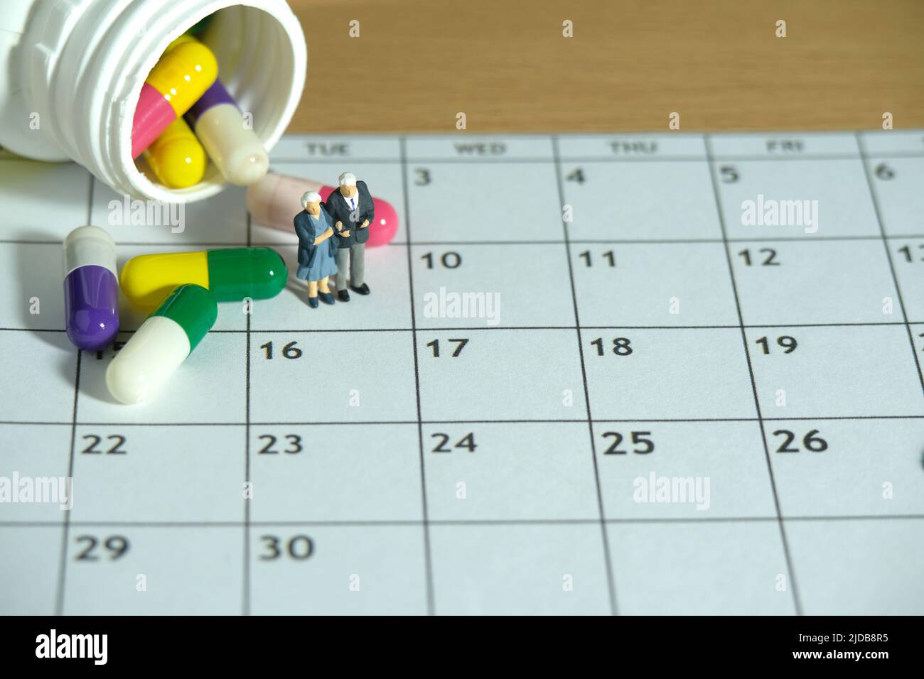 Miniature people toys conceptual photography. Elderly couple standing ...