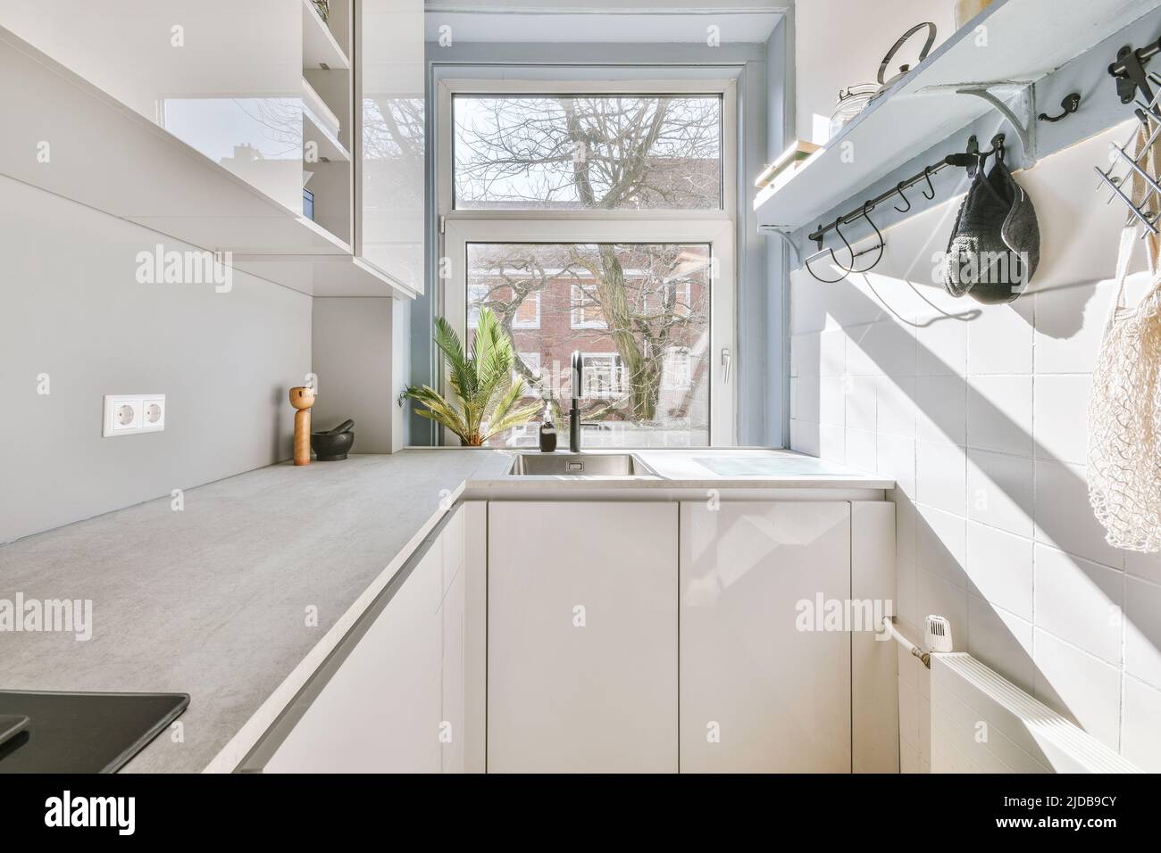 Well organized interior of a small home kitchen with a sink under the ...