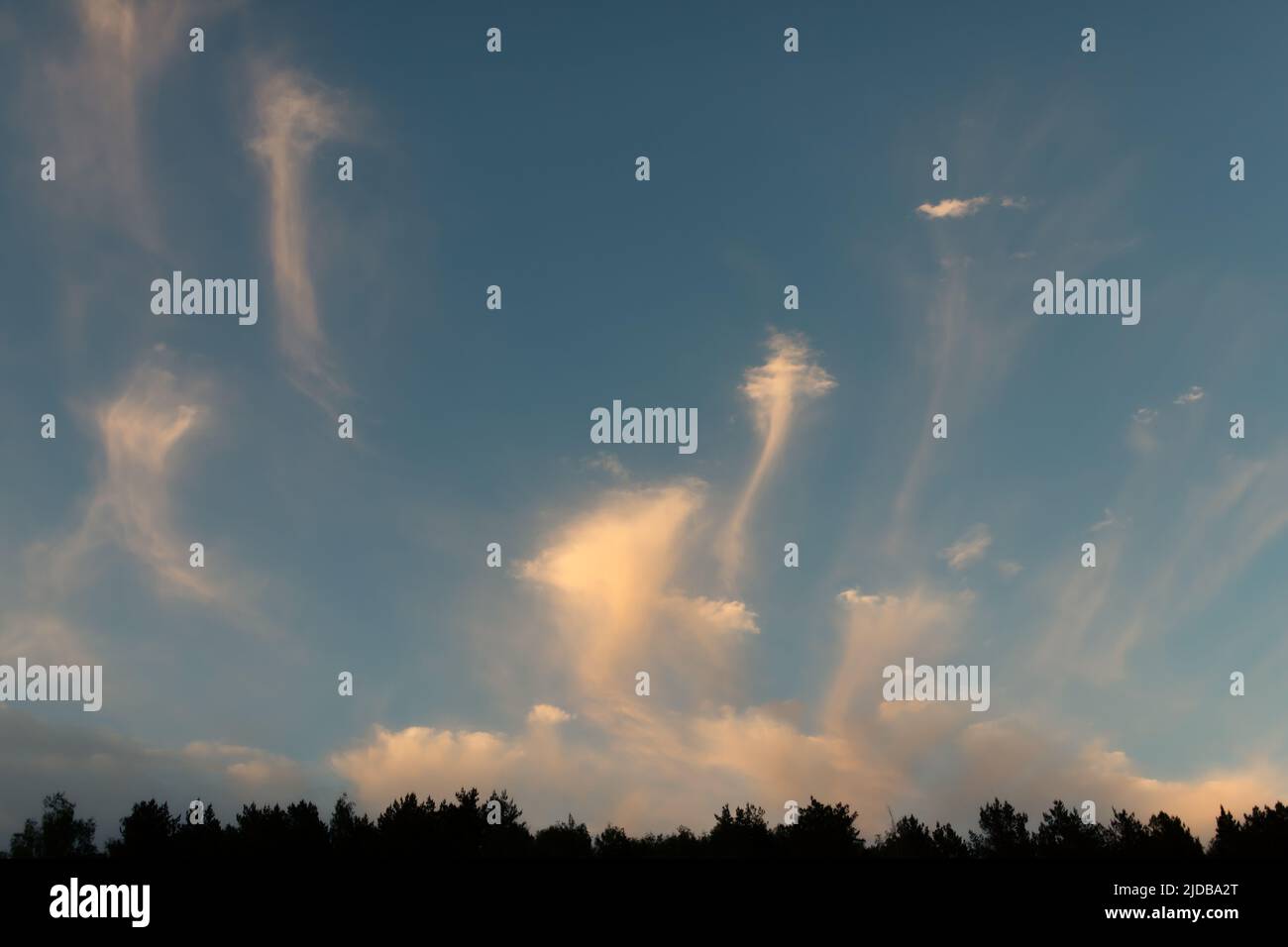 Spring blue sunset sky with bright clouds. Front view Stock Photo - Alamy