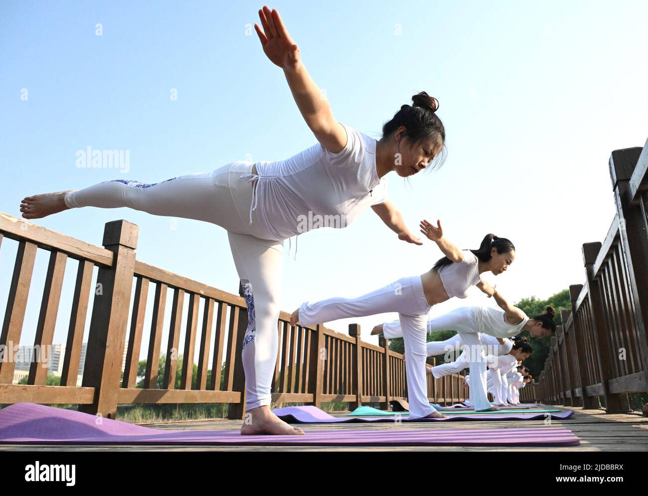 HANDAN, CHINA - JUNE 20, 2022 - Yoga enthusiasts practice yoga at ...
