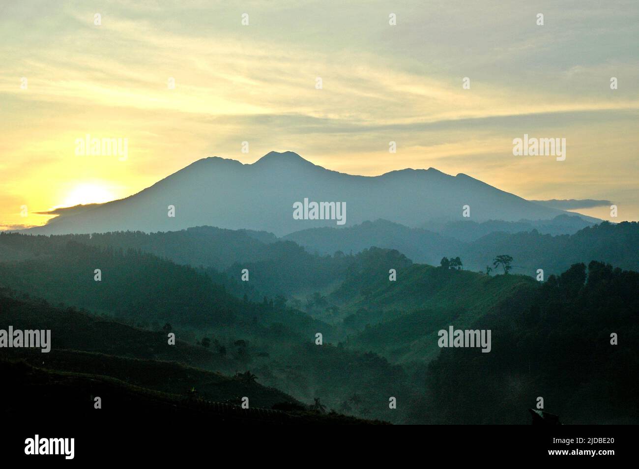 Mountain ridges covered with forest and bushes in a background of Mount ...