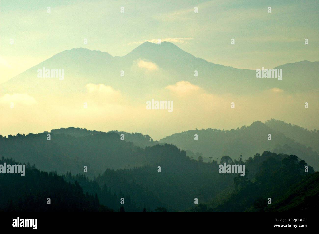Mountain ridges covered with forest and bushes in a background of Mount ...