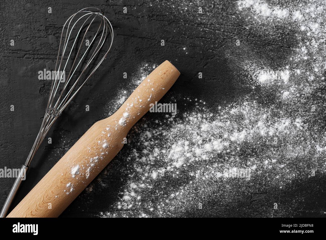 Scattered flour with rolling pin on black background Stock Photo - Alamy