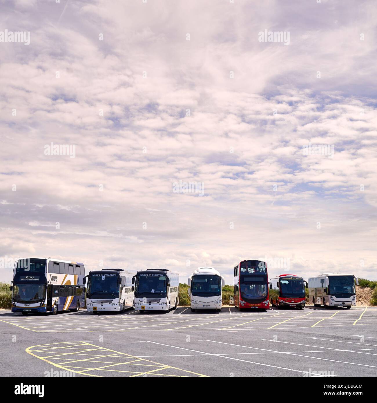 Line of coaches and buses on a tourist attraction car park on a summer ...