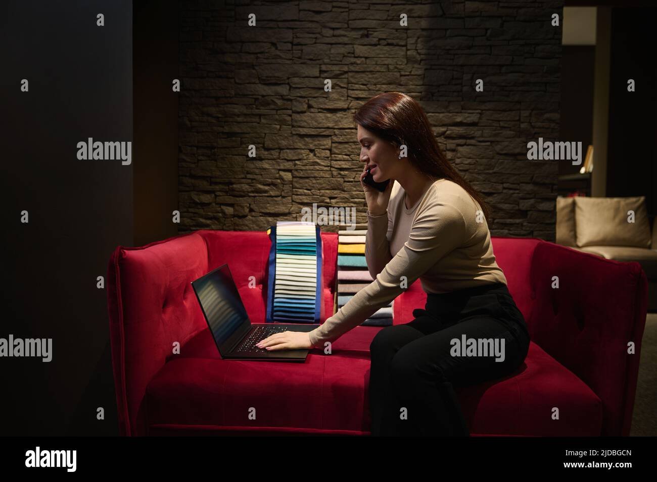 Experienced multitasking woman- interior designer talking on mobile ...