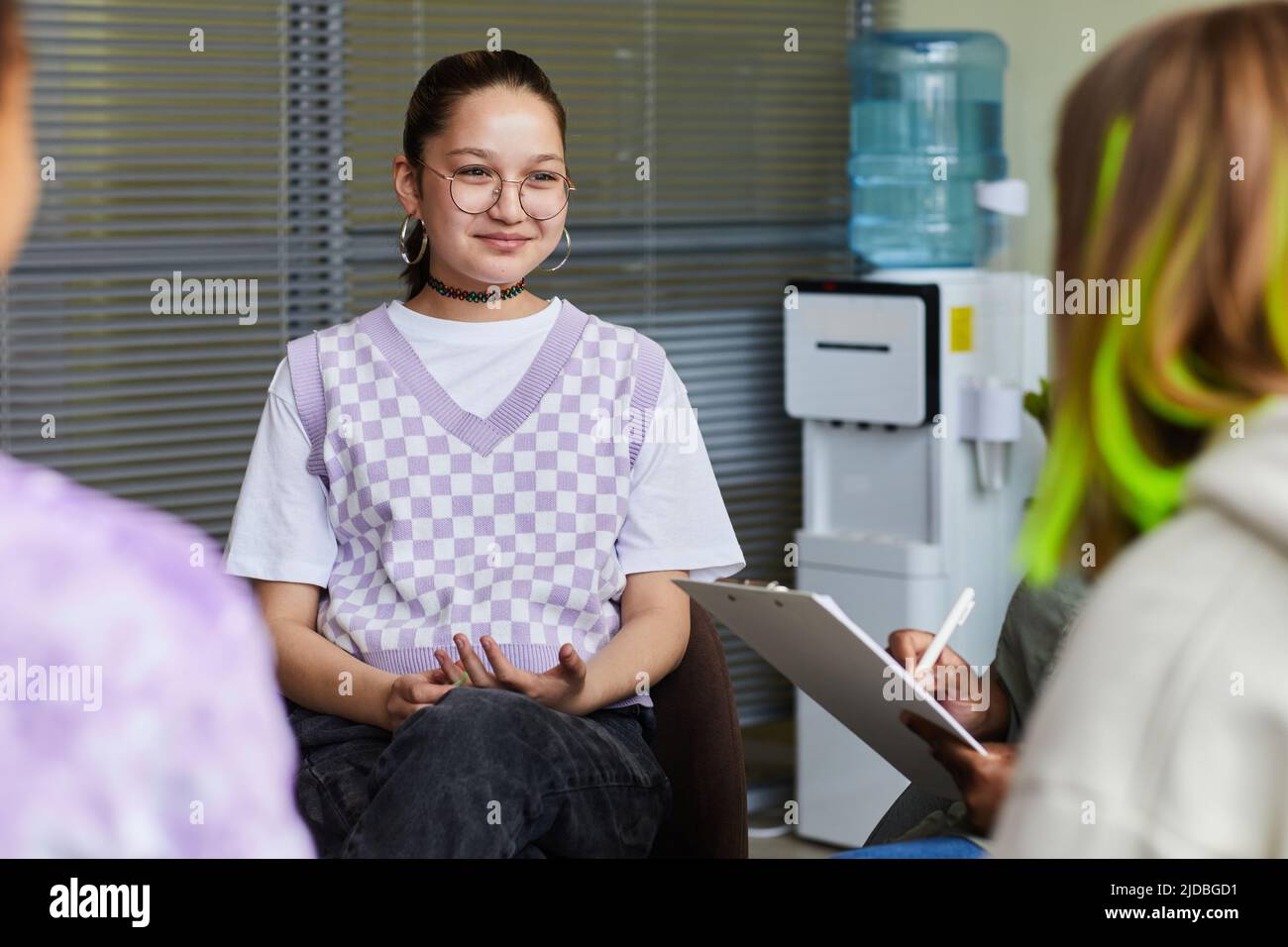 Difficult teenage girl talking about herself during psychotherapy ...