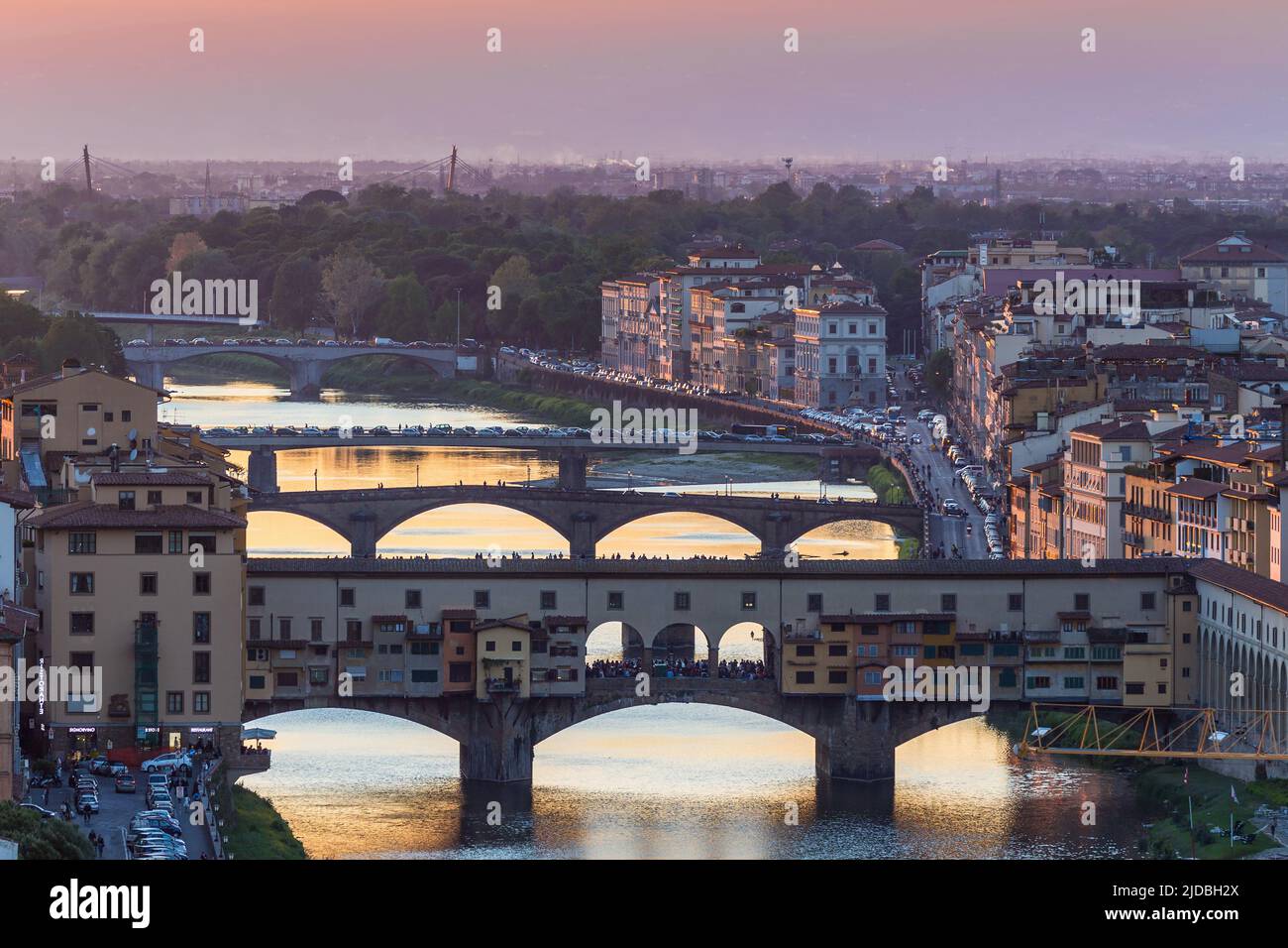 Ponte vecchio arch bridge at Arno river in Florence at dusk Stock Photo ...
