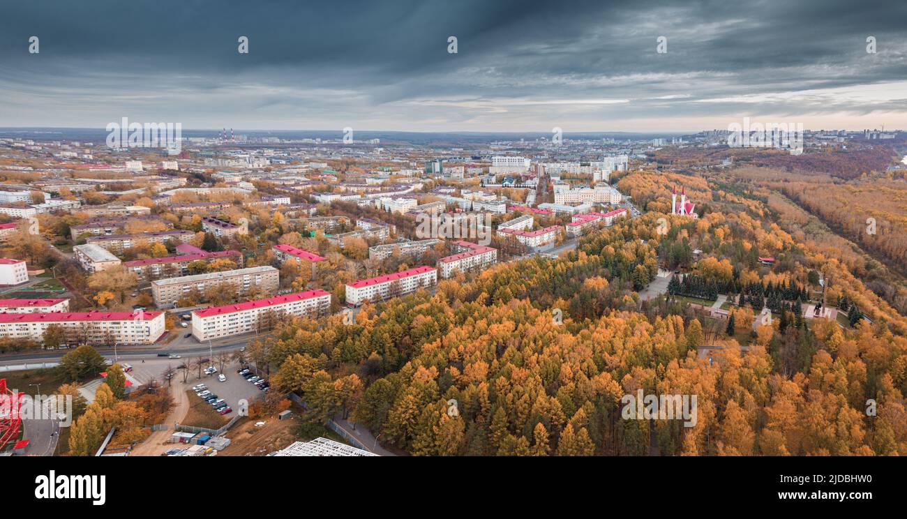 Aerial view of a city park and neighbourhood and residential block with ...