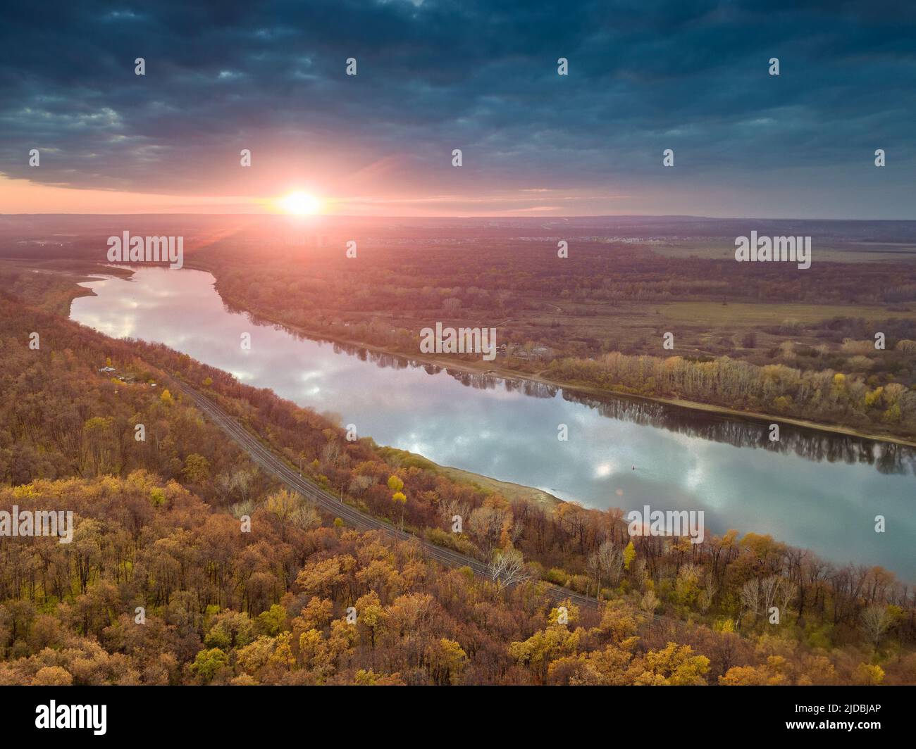 Aerial view of dramatic sunset sky reflecting in river, at autumn time ...