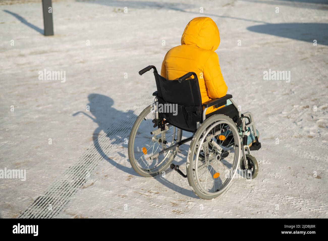 Homeless woman sitting in wheelchair in winter Stock Photo - Alamy