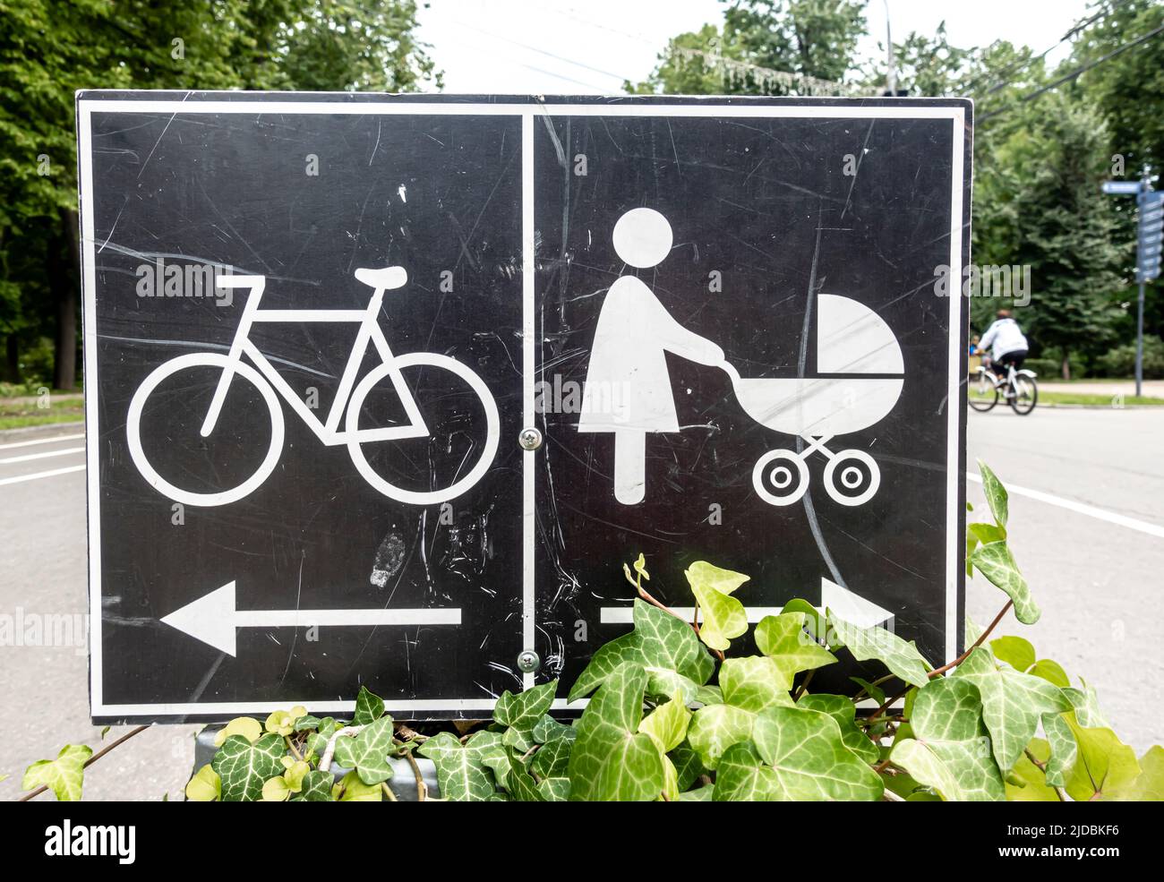 Street sign Woman with baby carriage and bicycle lane - arrow sign in a ...