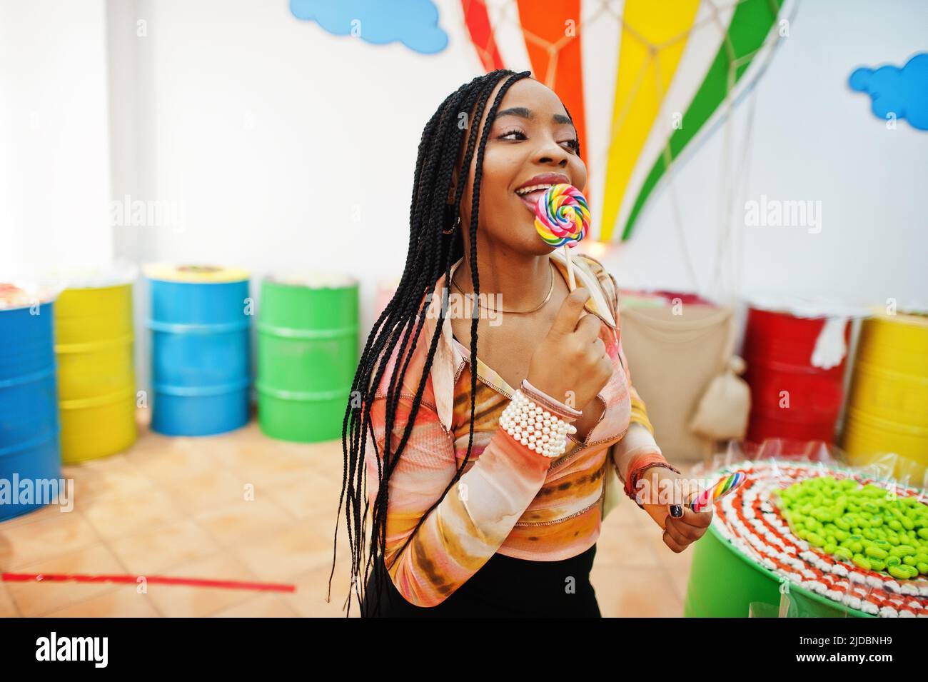 African american millennial lady at candy shop with lolipops Stock ...