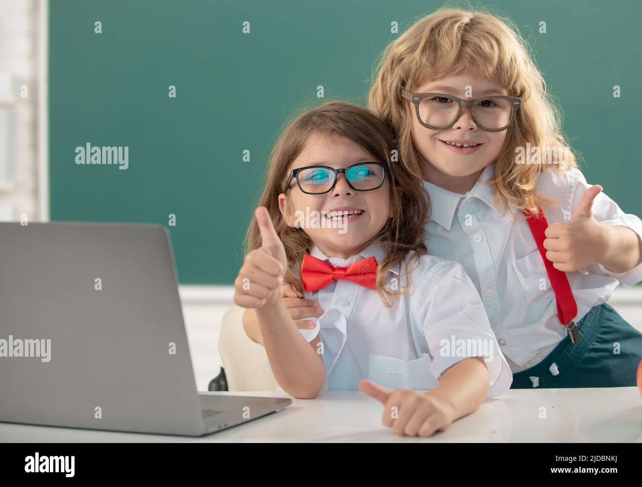 Back to school. Portrait of two happy school kids studying in classroom ...