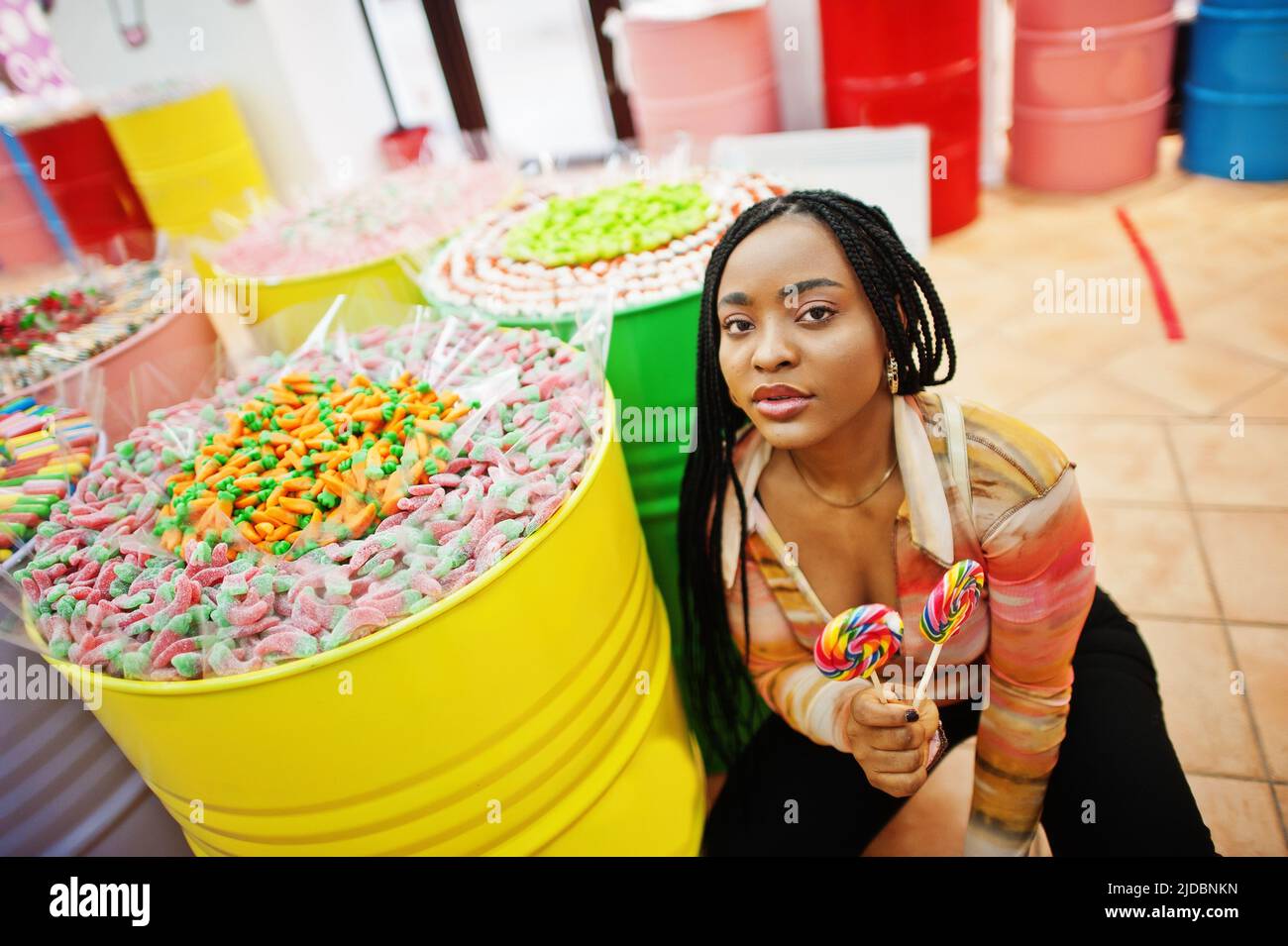 African american millennial lady at candy shop with lolipops Stock ...