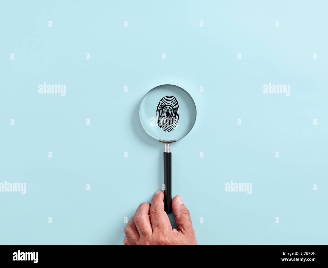 Male hand holds a magnifying glass or magnifier focusing on a ...