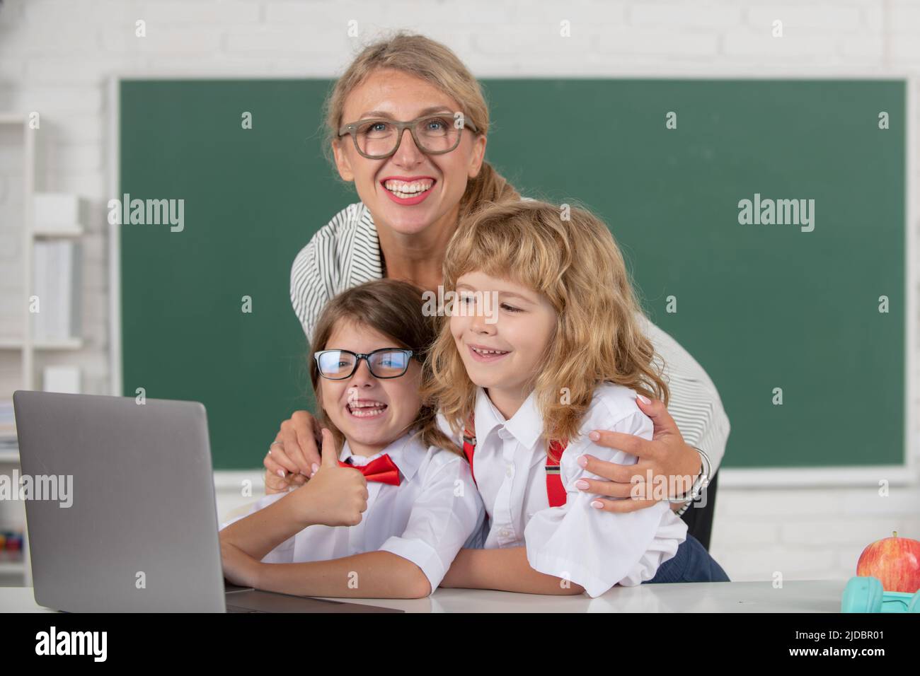 Kids learning with teacher. Children from elementary school study at ...