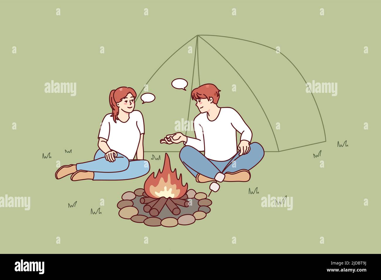 Happy man and woman sitting near campfire in forest. Smiling couple ...