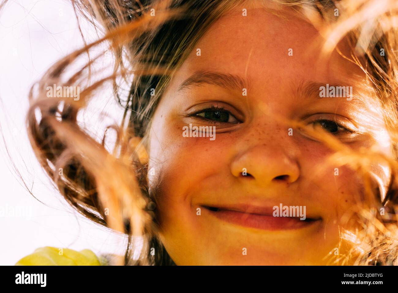 Blonde girl with long freckled hair and cute smile close up, child ...