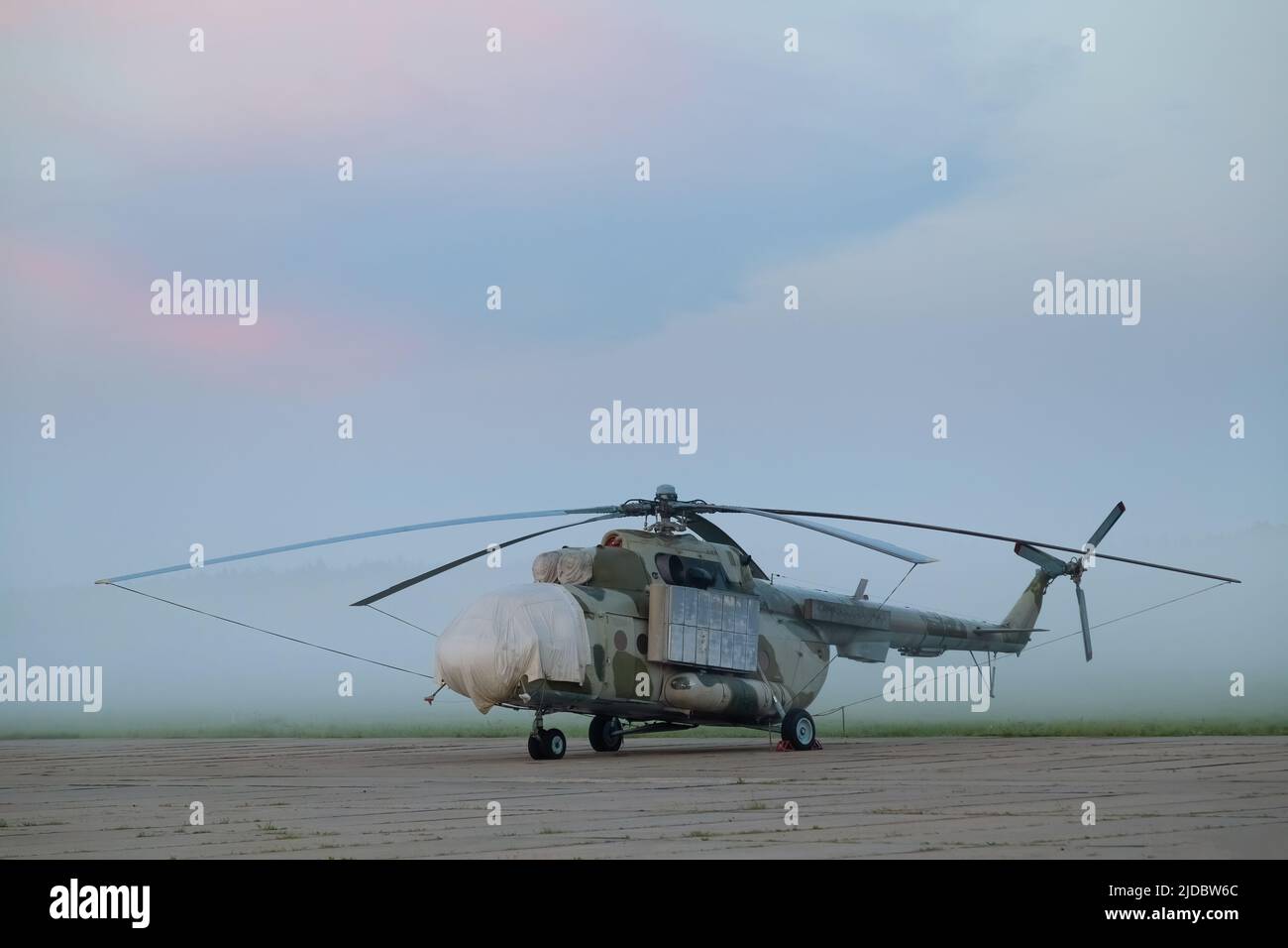 Military helicopters MI-8 at the airfield in the early morning before ...