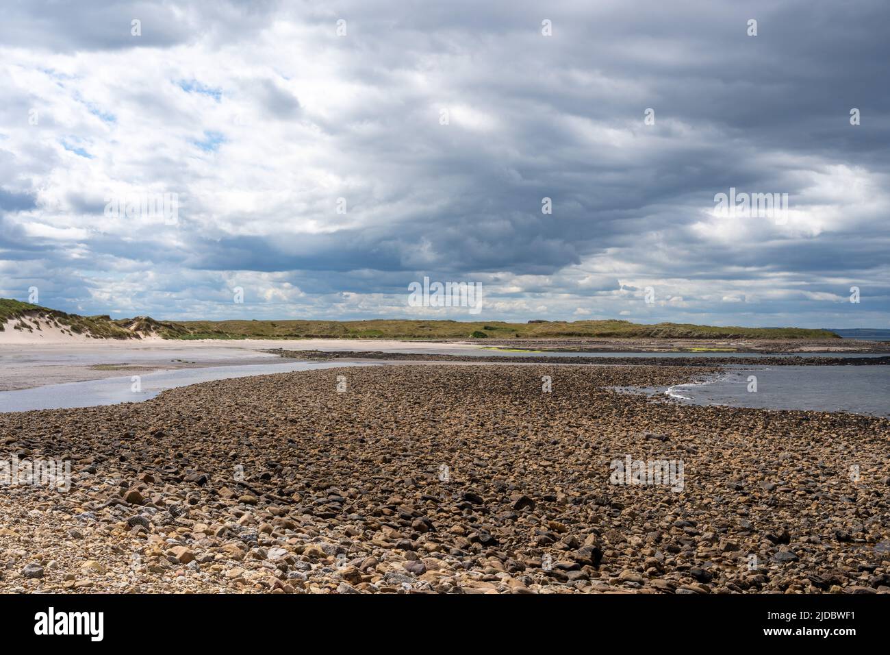 The Rocky shore at Sandham Bay, on the north coast of The Holy Island ...