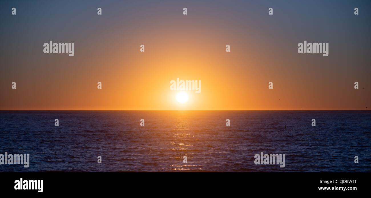 Sunset over sea with golden dramatic sky panorama. Calm sea with sunset ...