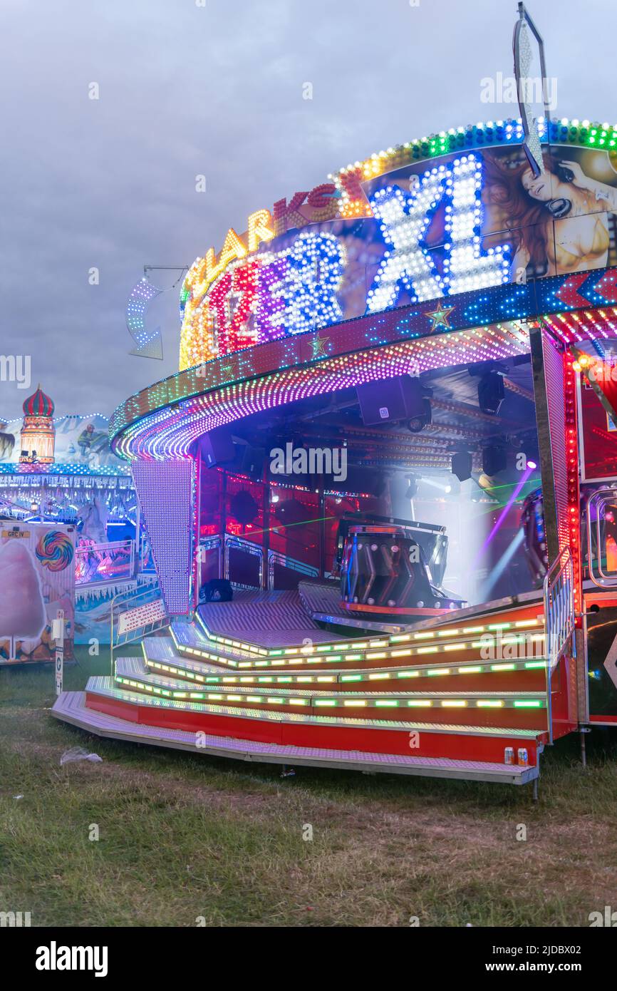 The Waltzer XL funfair ride in full swing, under an evening sky. The ...