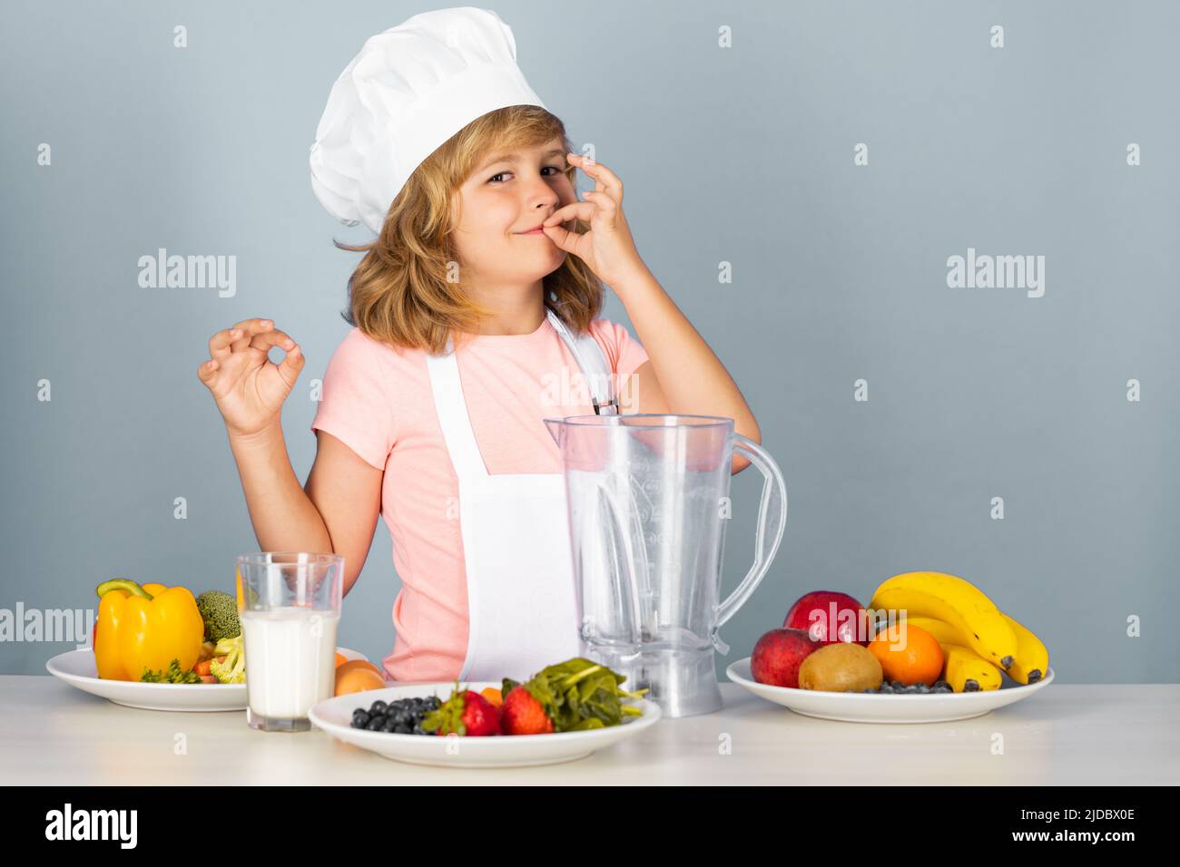 Fruits and vegetables for kids. Child chef dressed cook baker apron and ...
