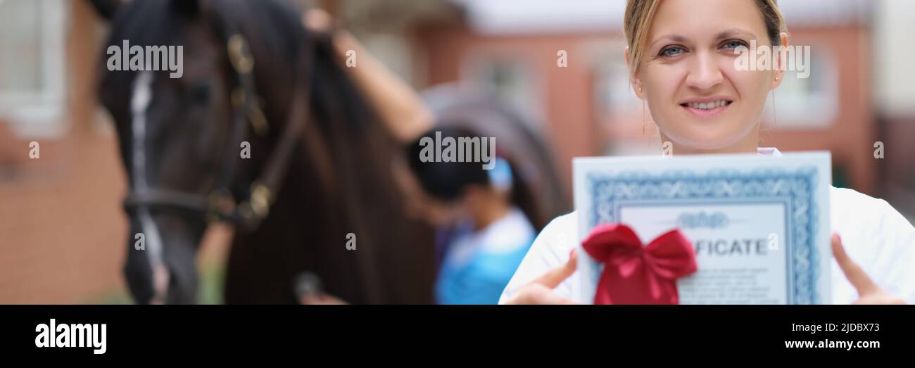 Woman doctor shows horse veterinary certificate Stock Photo - Alamy