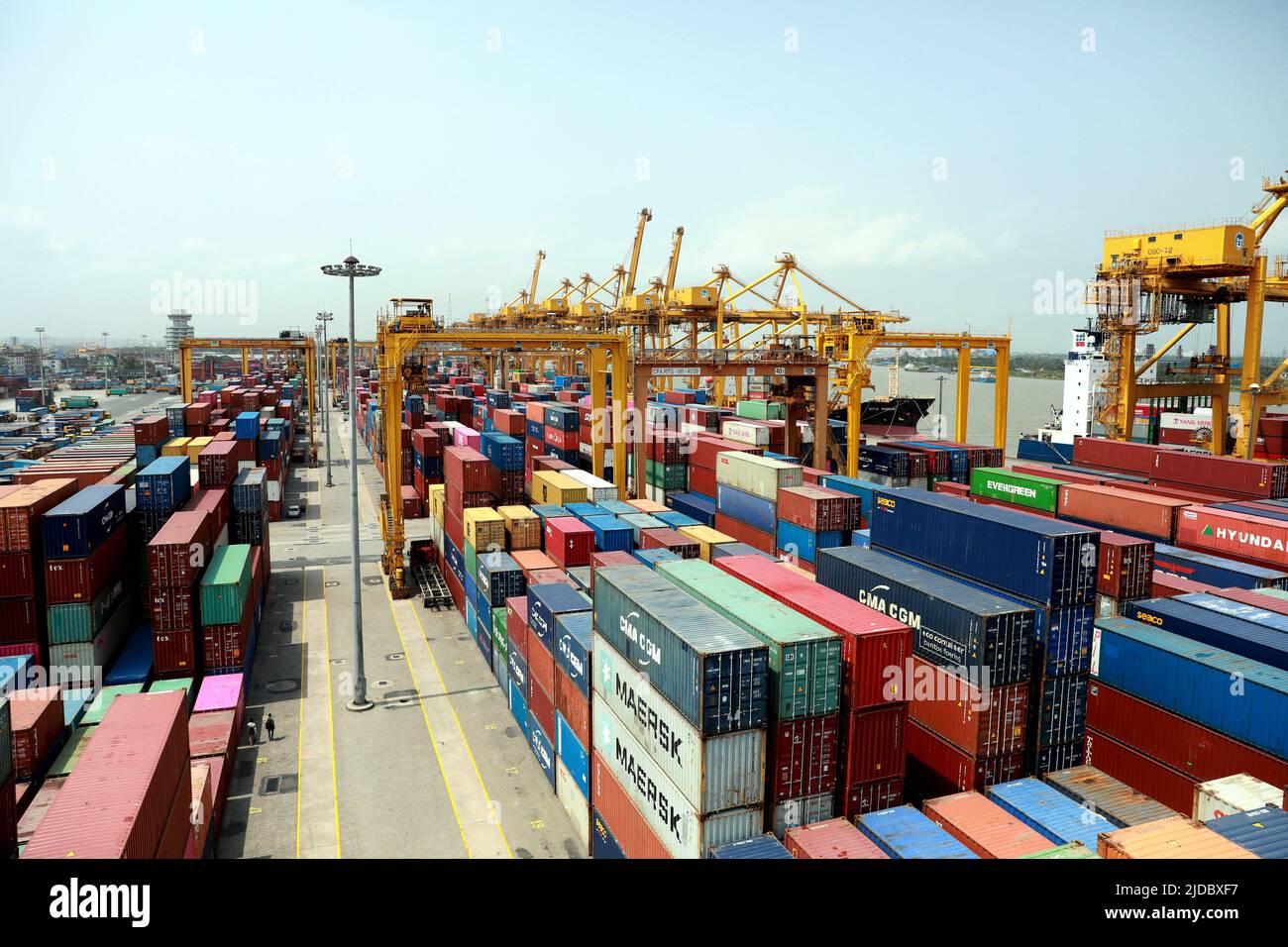 Aerial view of containers and shipyard cranes and trucks are at ...
