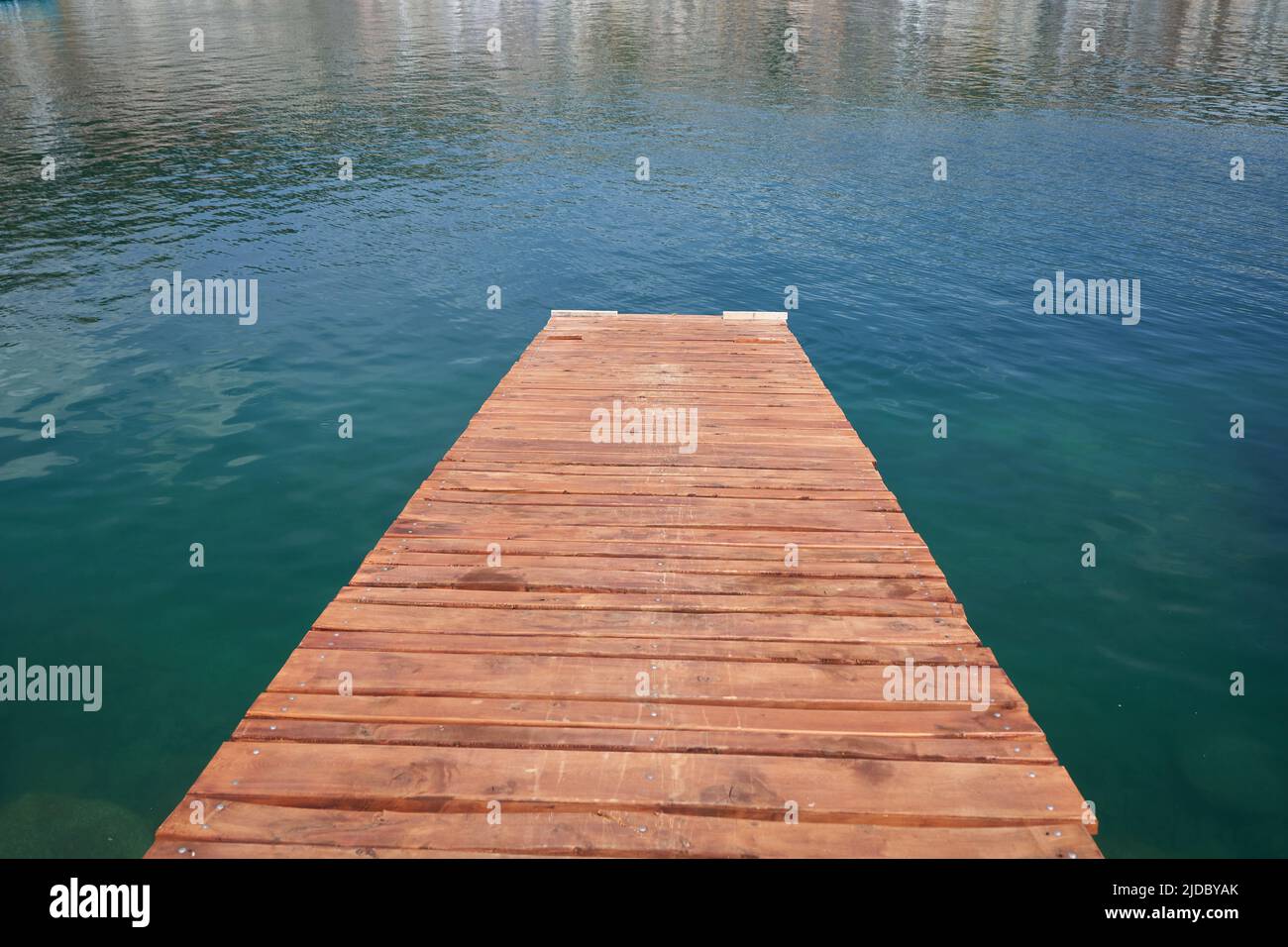 Wooden pier in the sea for boarding a boat Stock Photo - Alamy