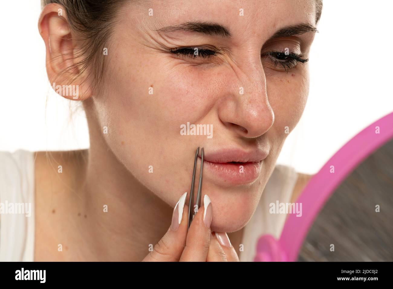hair over the upper lip in women. girl with tweezers plucks a mustache ...
