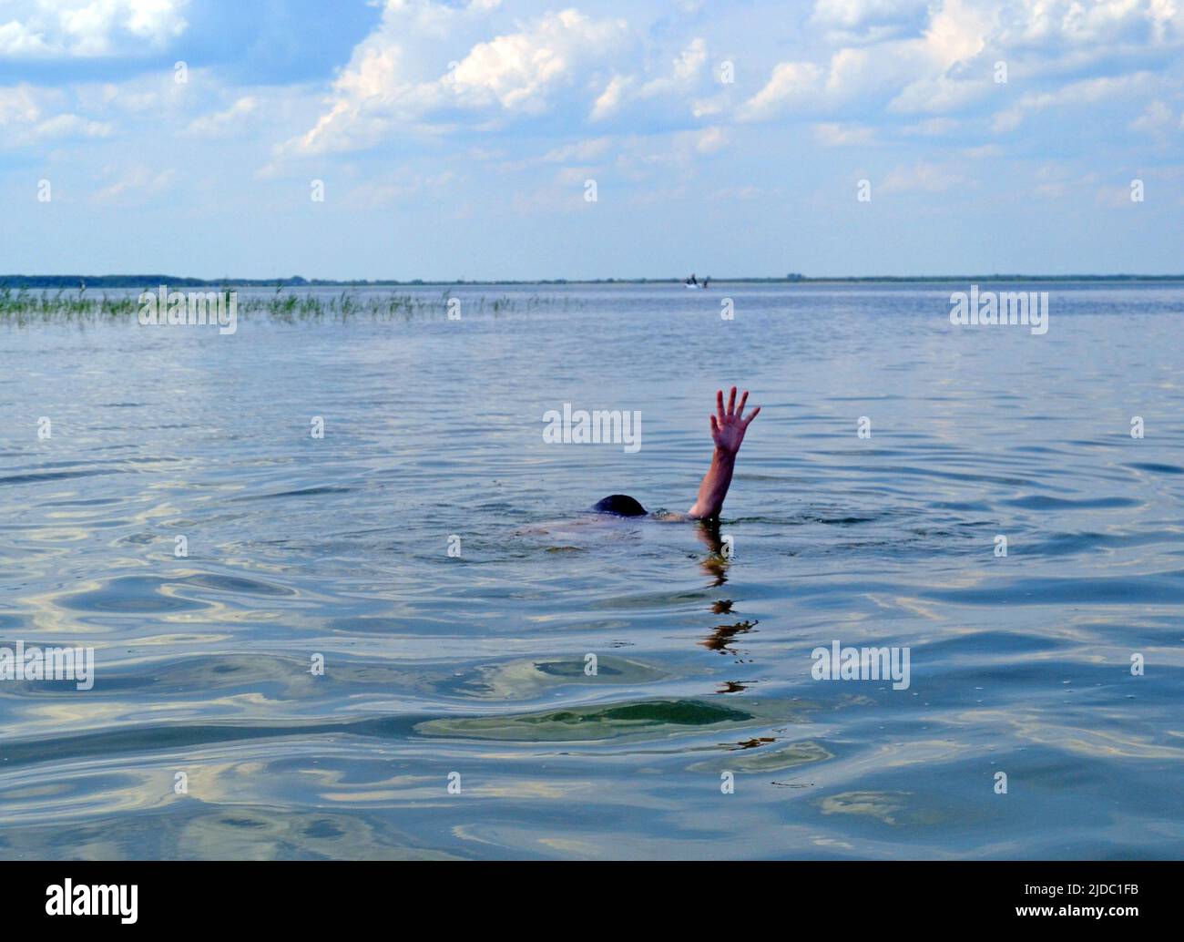 Hands of a drowning man above water in need of help Stock Photo - Alamy