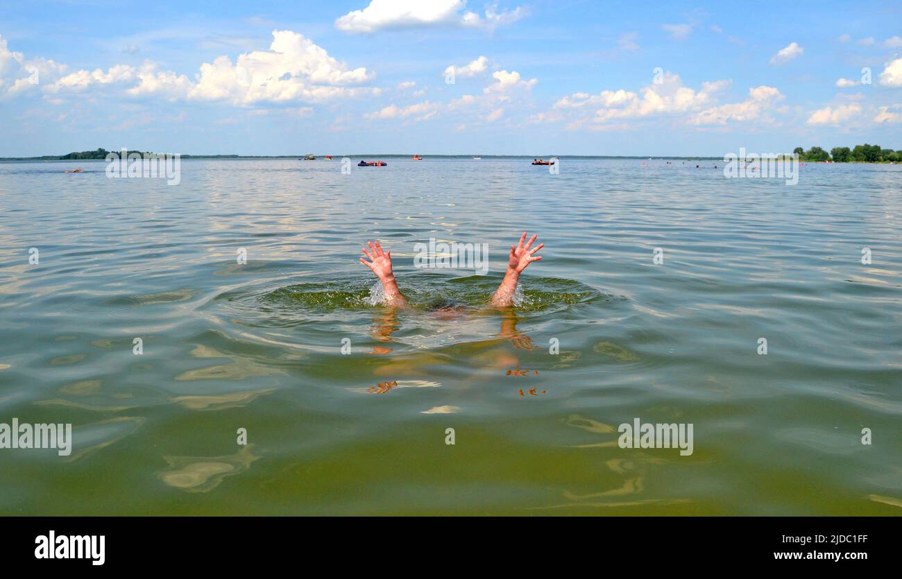 Hands of a drowning man above water in need of help Stock Photo - Alamy