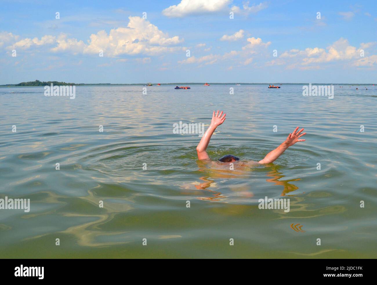 Hands of a drowning man above water in need of help Stock Photo - Alamy