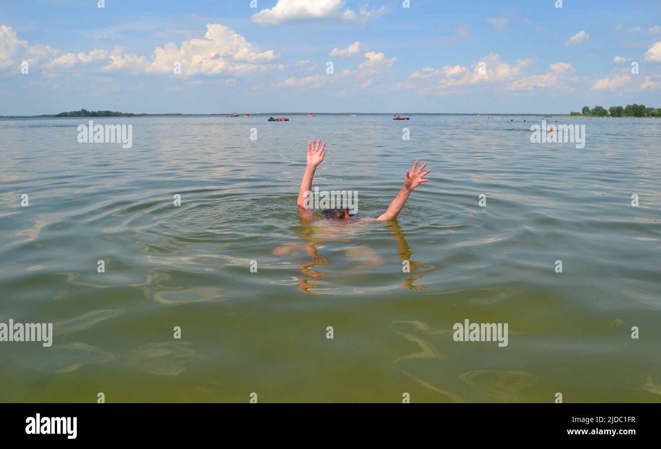 Hands of a drowning man above water in need of help Stock Photo - Alamy